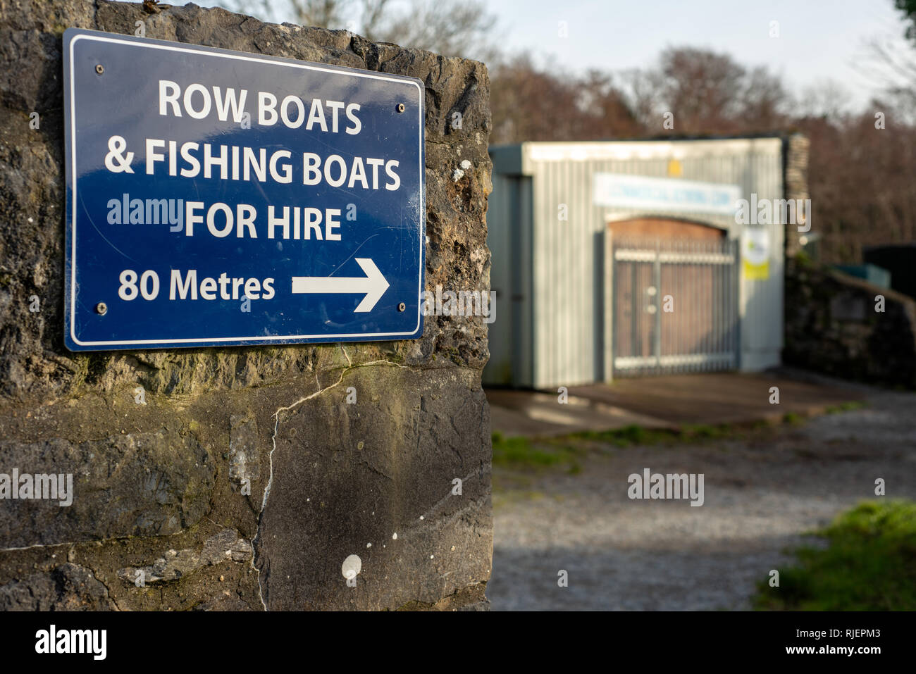 Boats for hire sign. Row boats and fishing boats for hire sign at pier ...