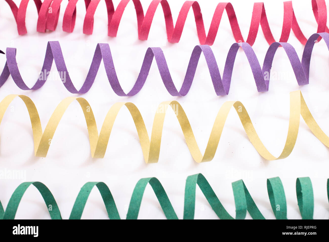 Mixed colorful streamers on a white background Stock Photo - Alamy