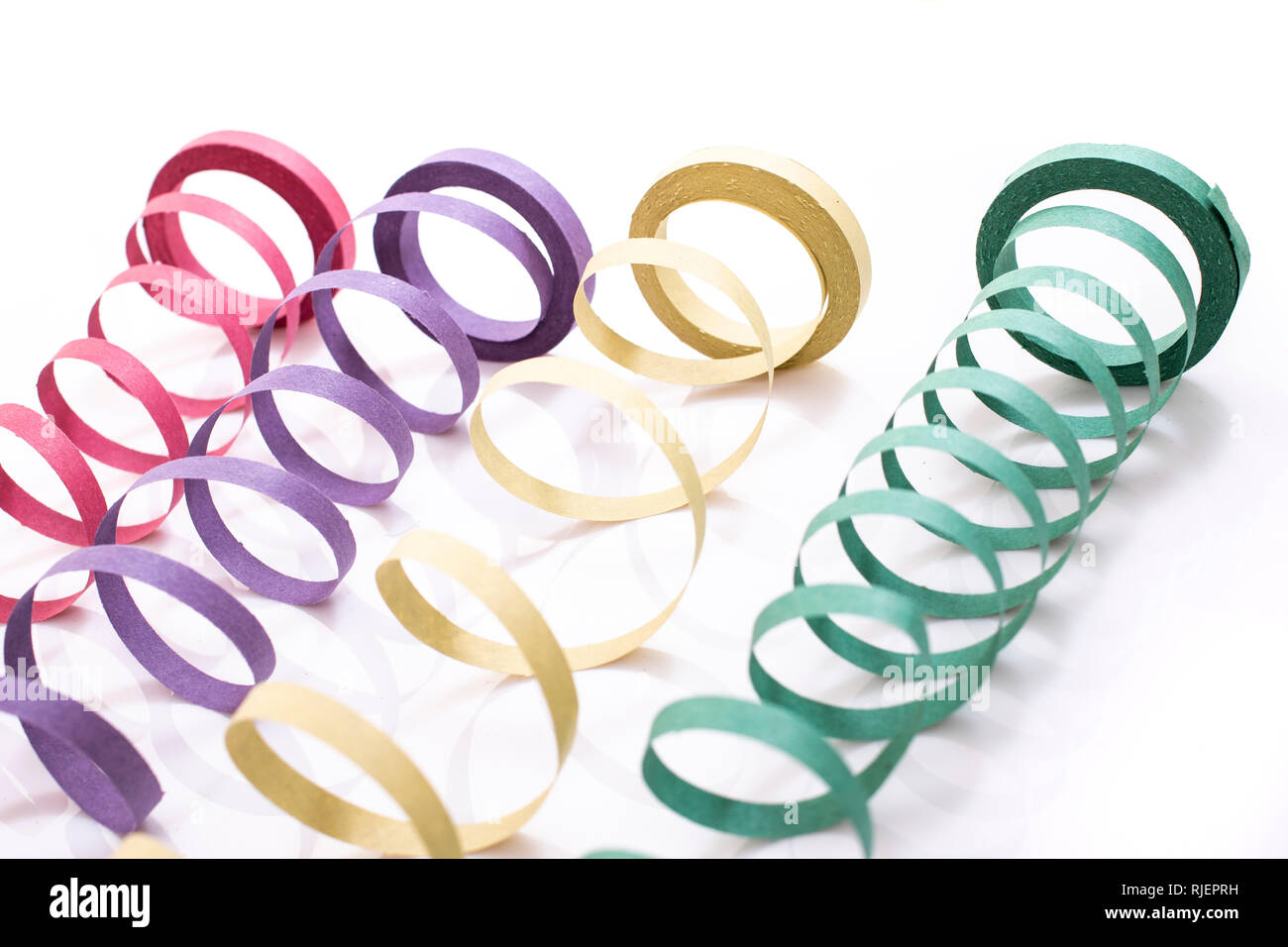 Mixed colorful streamers on a white background Stock Photo - Alamy