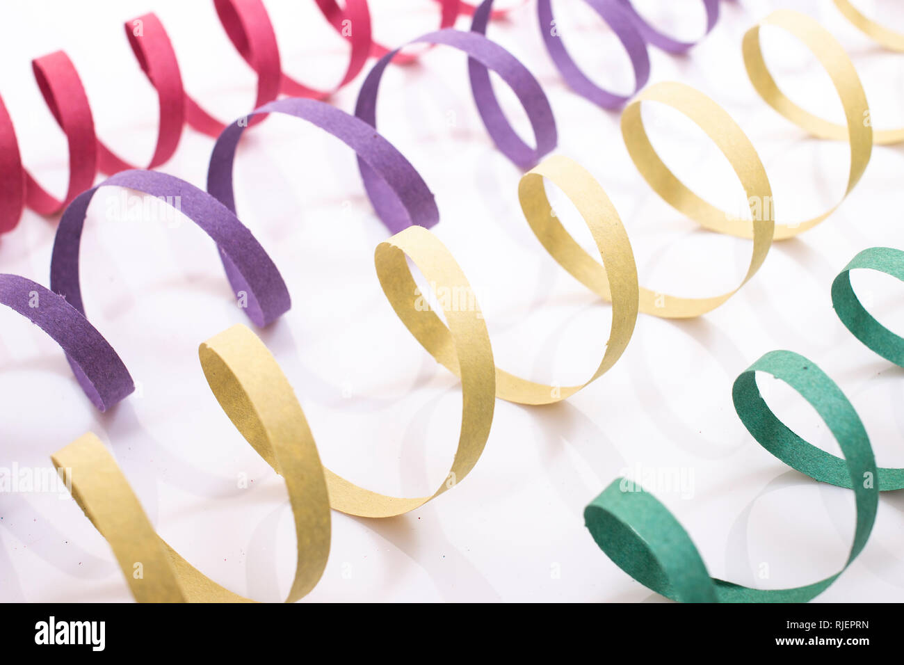 Mixed colorful streamers on a white background Stock Photo - Alamy