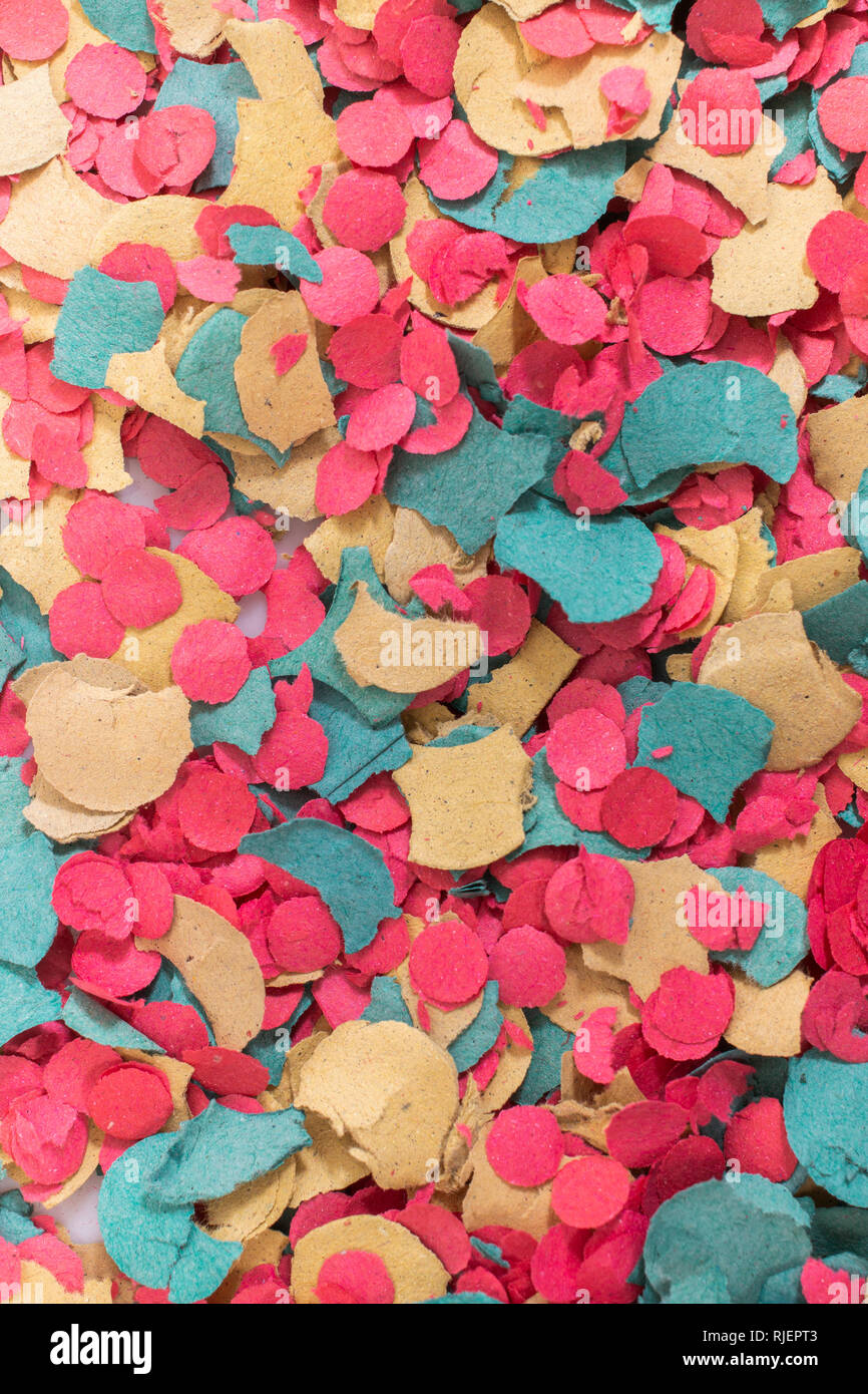 Mixed colorful confetti scattered on a pile Stock Photo - Alamy