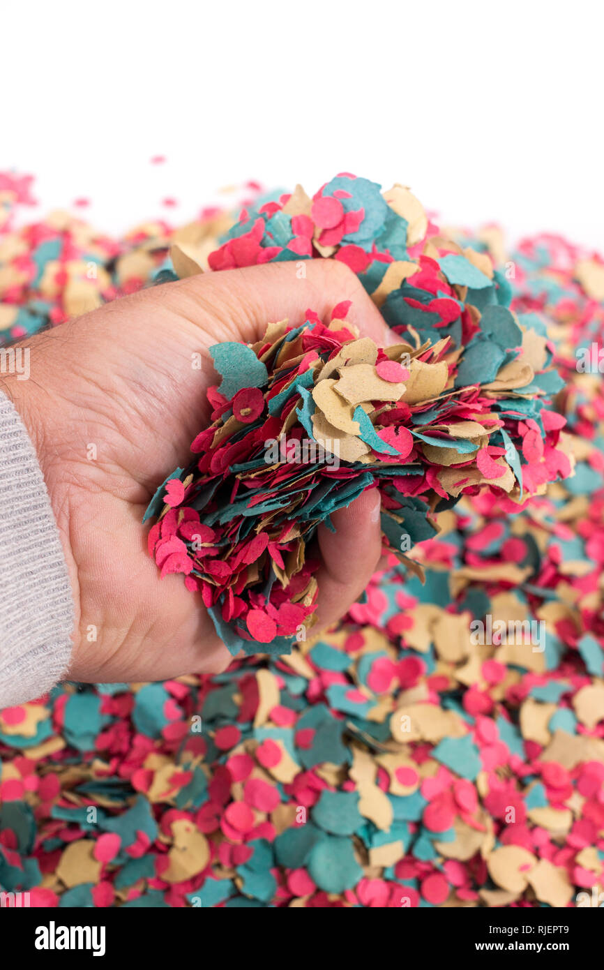 Hand grabs a mix of colorful confetti Stock Photo - Alamy