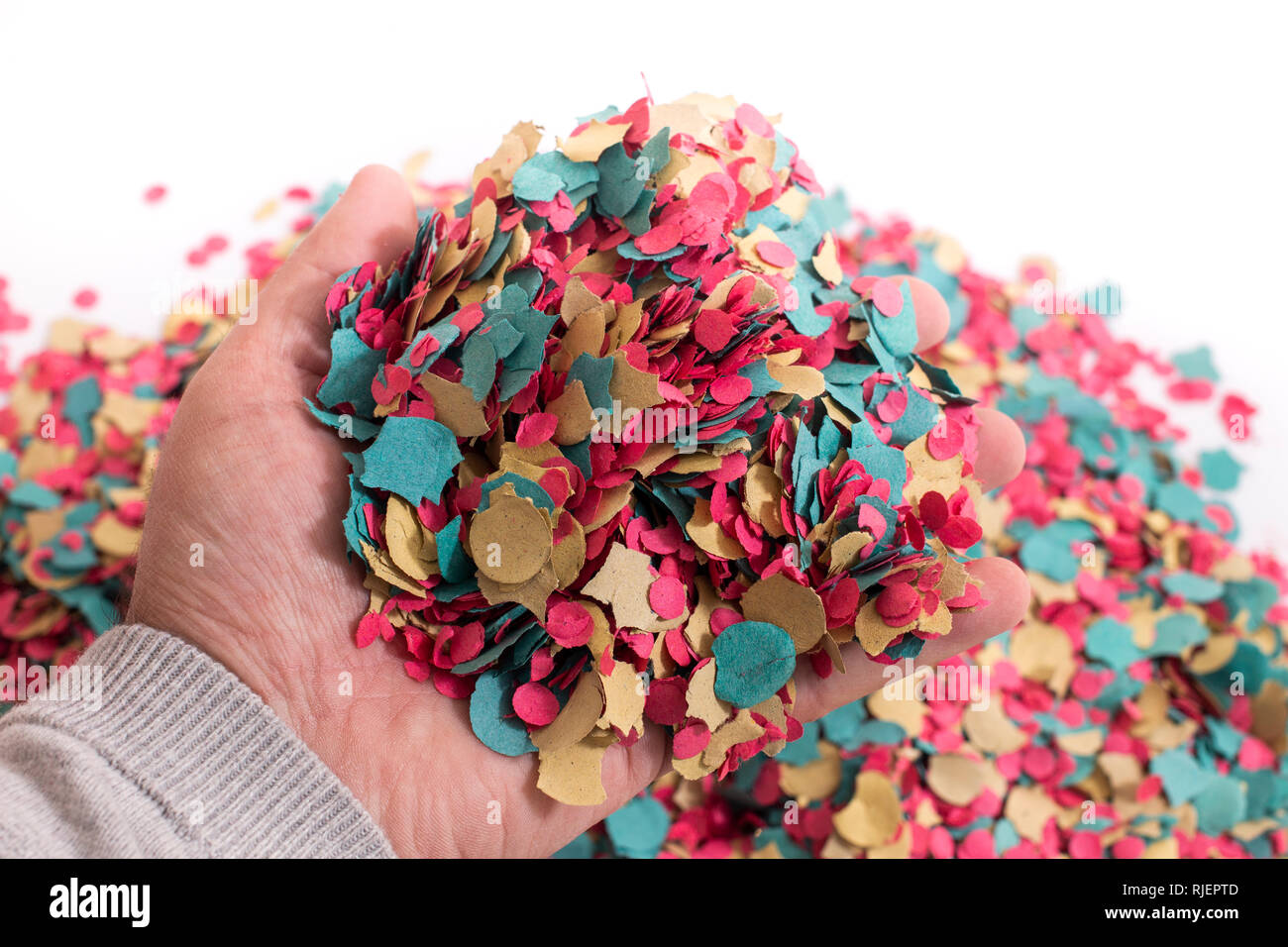 Hand grabs a mix of colorful confetti Stock Photo - Alamy