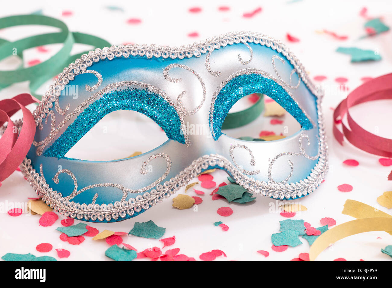 blue venetian mask with confetti isolated on a white background Stock ...