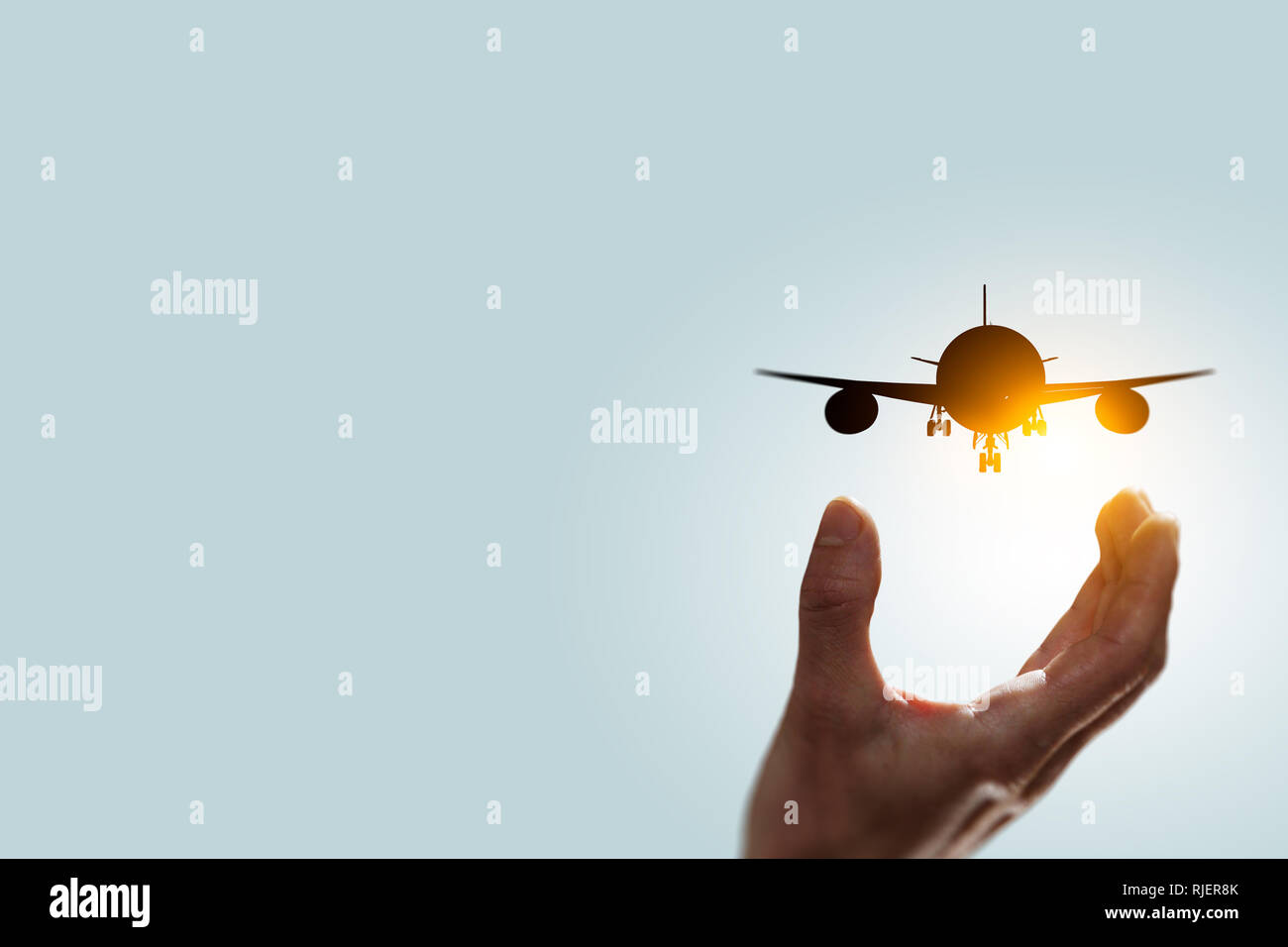 Hand of businessman holding airplane model in palm Stock Photo - Alamy