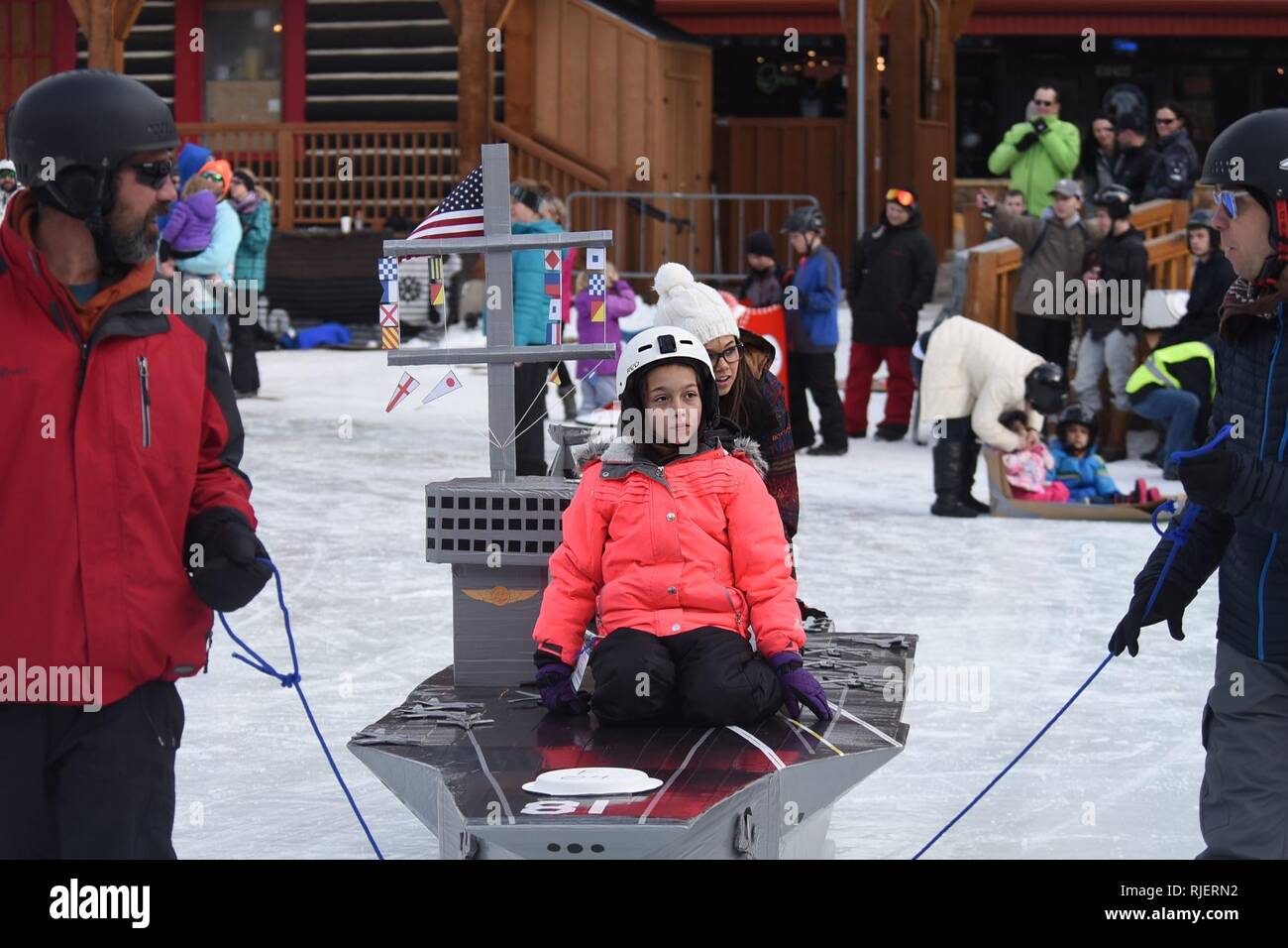 Jordan Bard is carried by teammates Dan Bard, left, Kevin Rupp, right ...