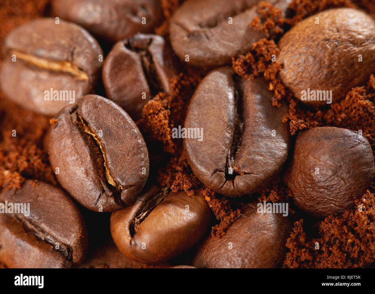 Close up photo of Coffee beans and ground coffee Stock Photo - Alamy