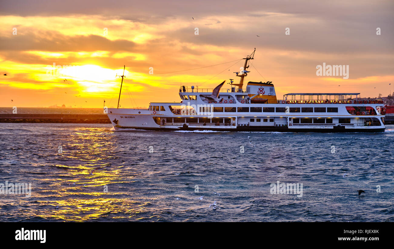 Passenger ferry as it enters the port of Kadikoy at sunset, on the ...