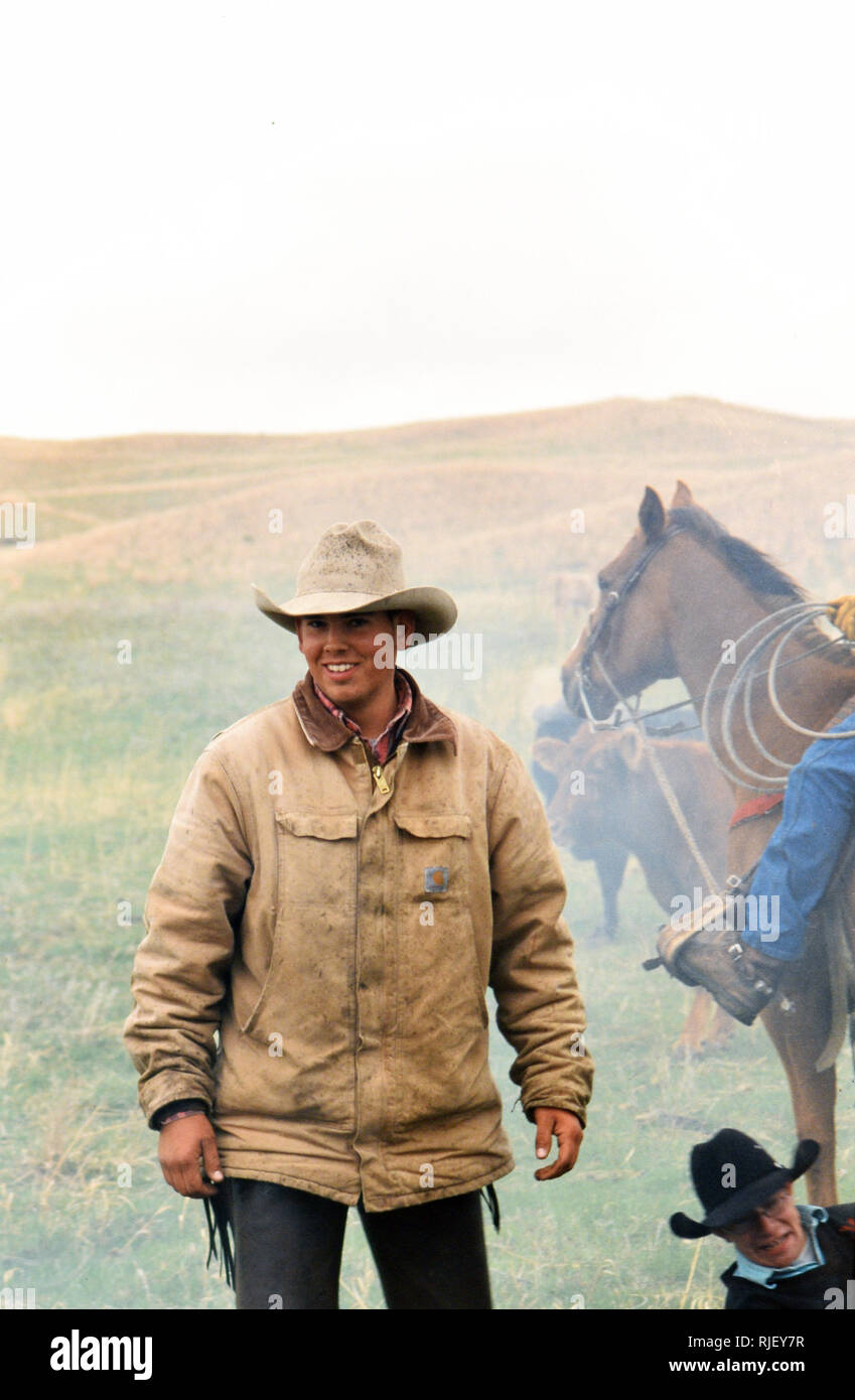 Cold smiling cowboy wearing a Carhart coat on a Nebraska ranch Stock ...