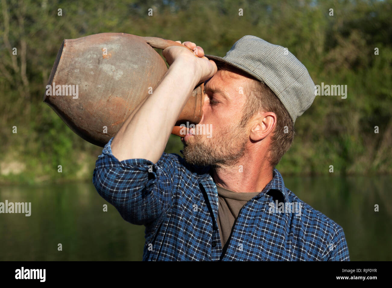 Man drinking from the jug Stock Photo - Alamy