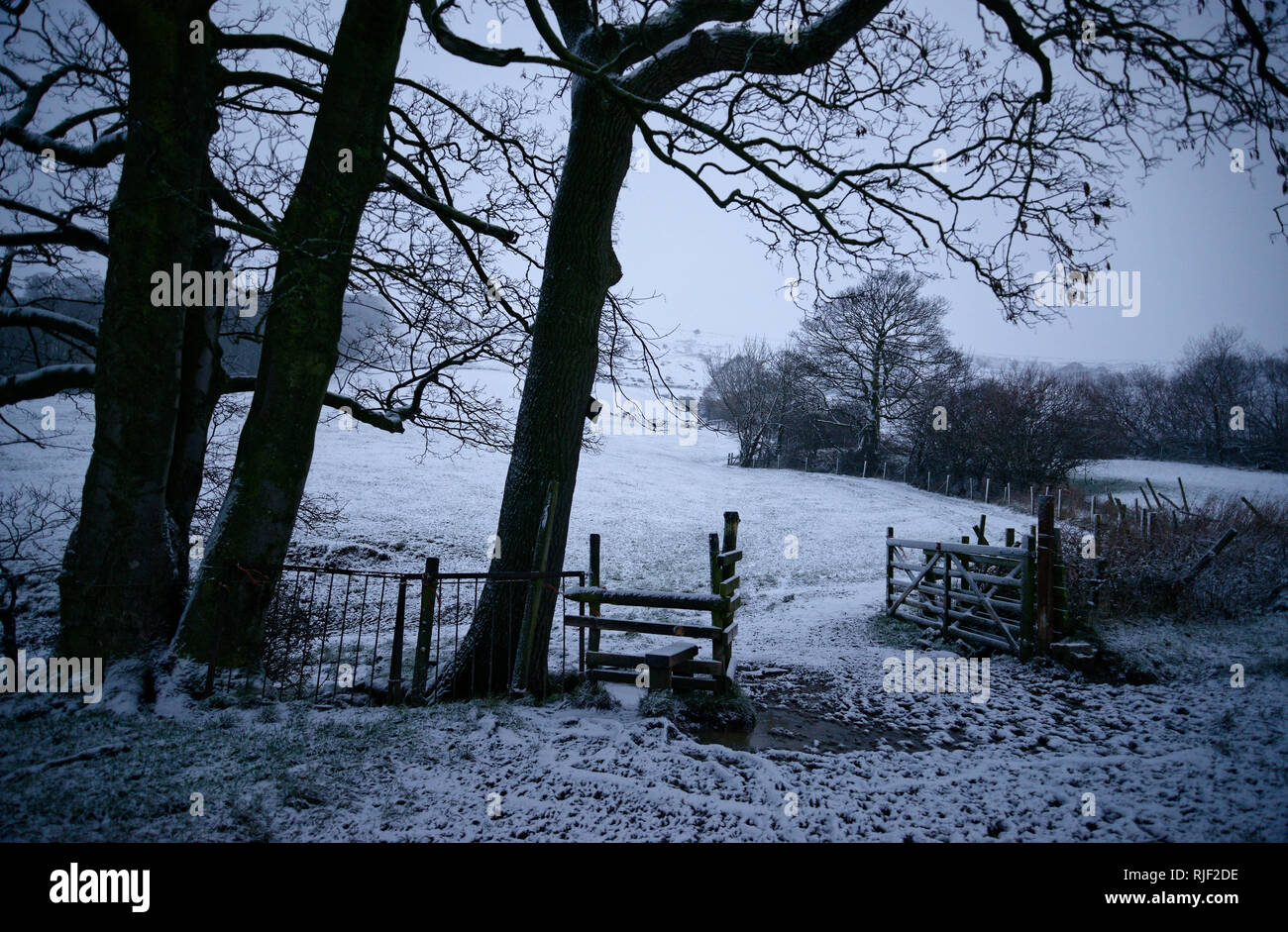 Snowy dawn in the Peak District National Park, England. Twilight light ...