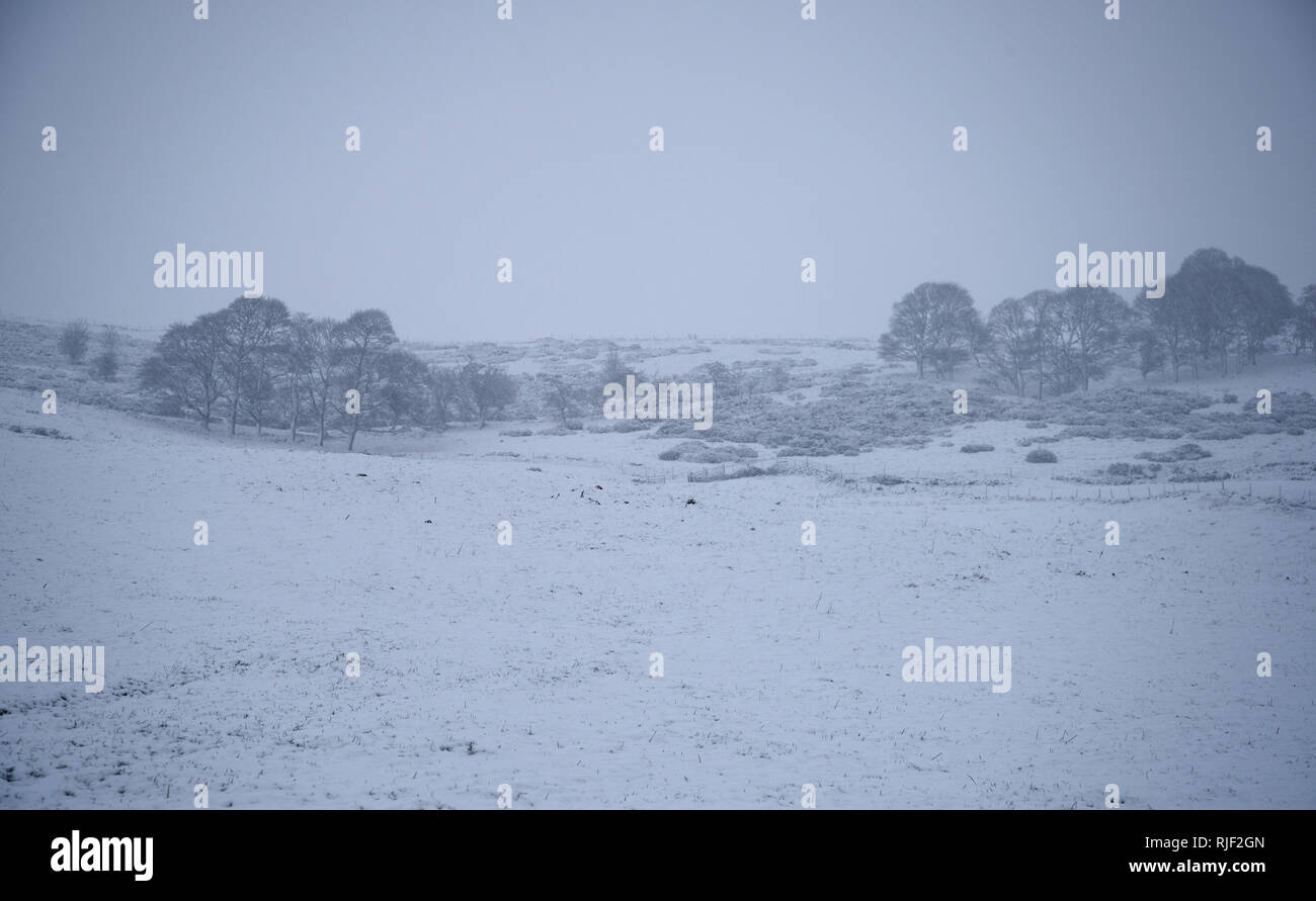 Snowy dawn in the Peak District National Park, England. Twilight light ...