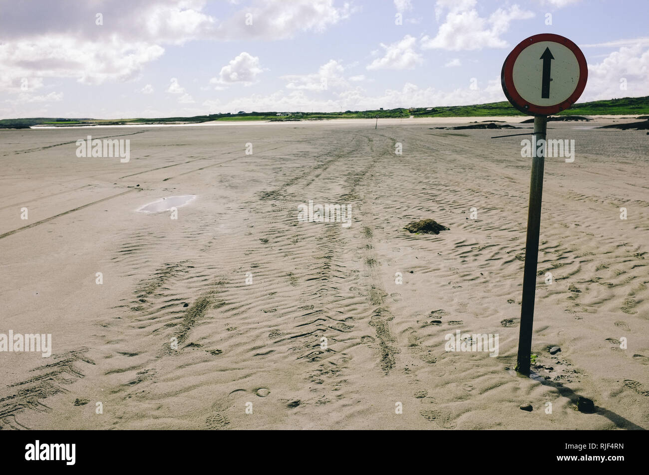 a road over the beach with traffic sign Stock Photo - Alamy