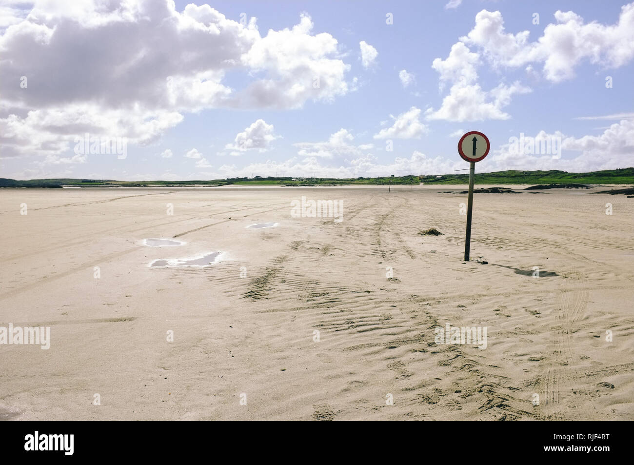 a road over the beach with traffic sign Stock Photo - Alamy
