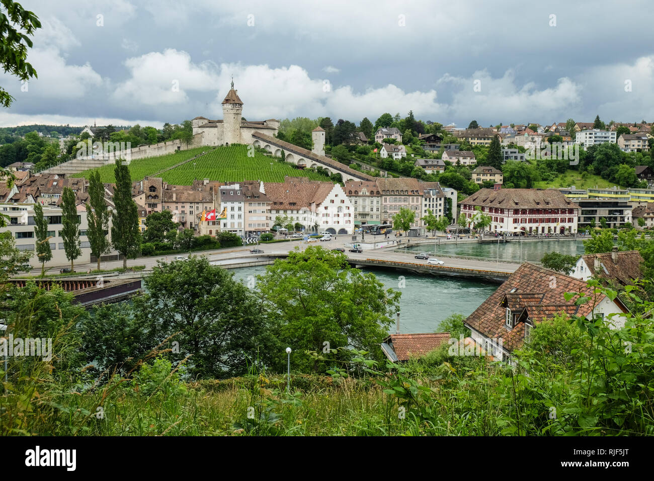 A view of a castle on a hill above a small town Stock Photo - Alamy