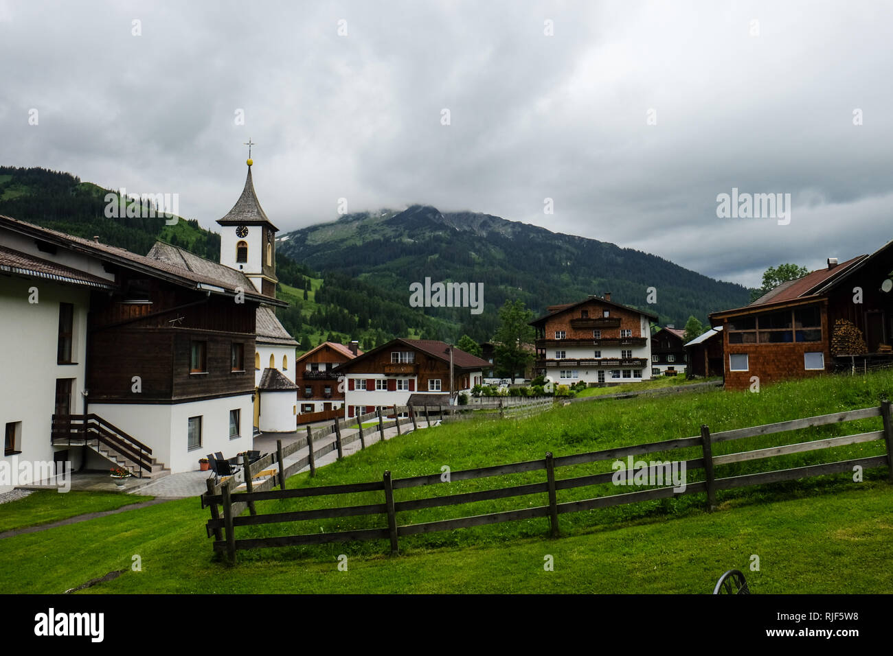 a small austrian village with typical houses and a church Stock Photo ...