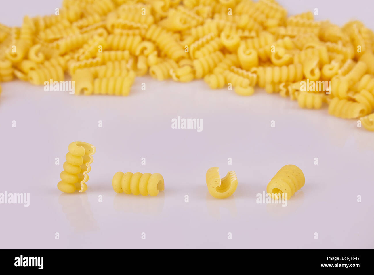 Raw pasta background. Uncooked pasta tubules background. Food ...