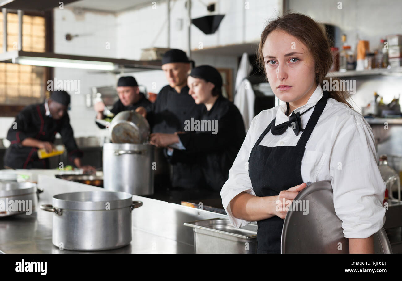 Tired and upset waitress in kitchen of restaurant Stock Photo - Alamy