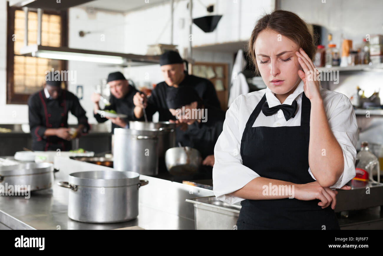 Tired and upset waitress in kitchen of restaurant Stock Photo - Alamy