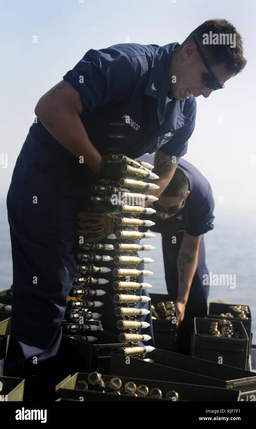 Petty Officer 2nd Class Joshua Pacheco downloads ammunition from a ...