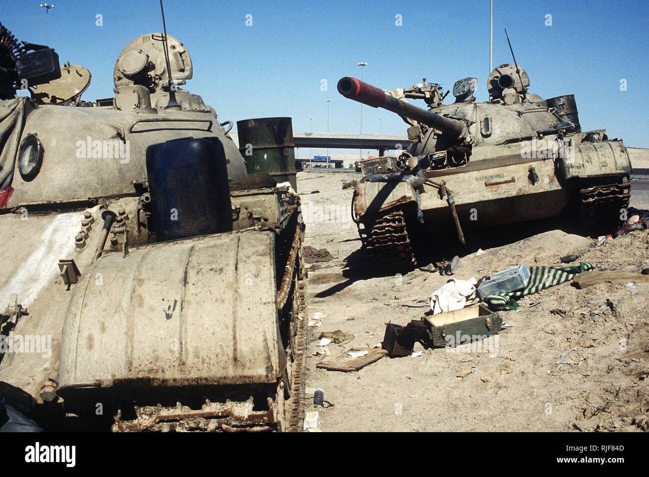 Two Iraqi T-55 main battle tanks lie abandoned on the Basra-Kuwait ...