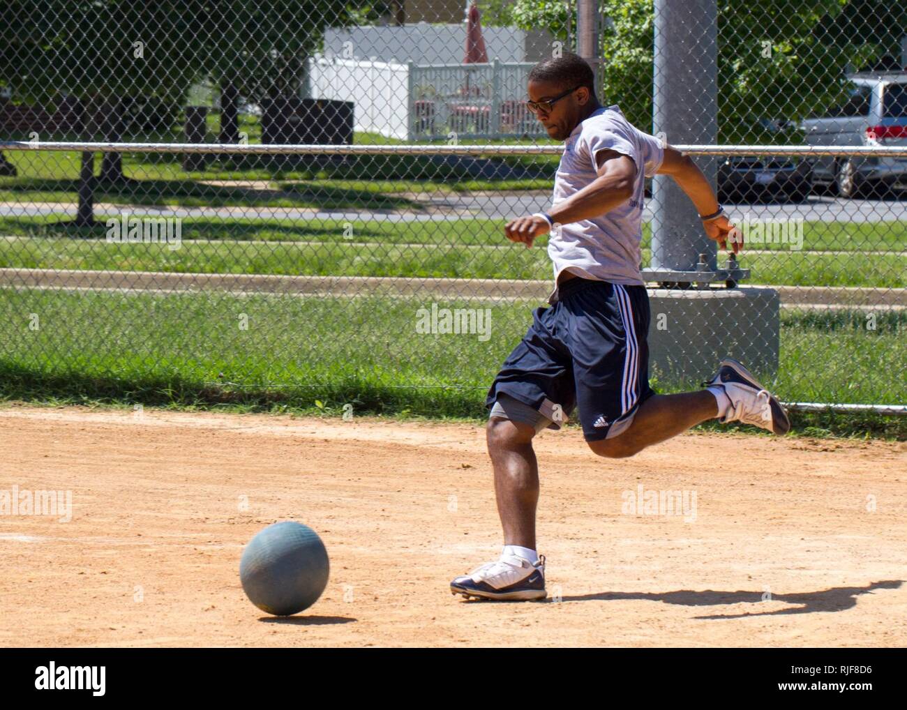 A service member winds up to kick the ball during an intense game of ...