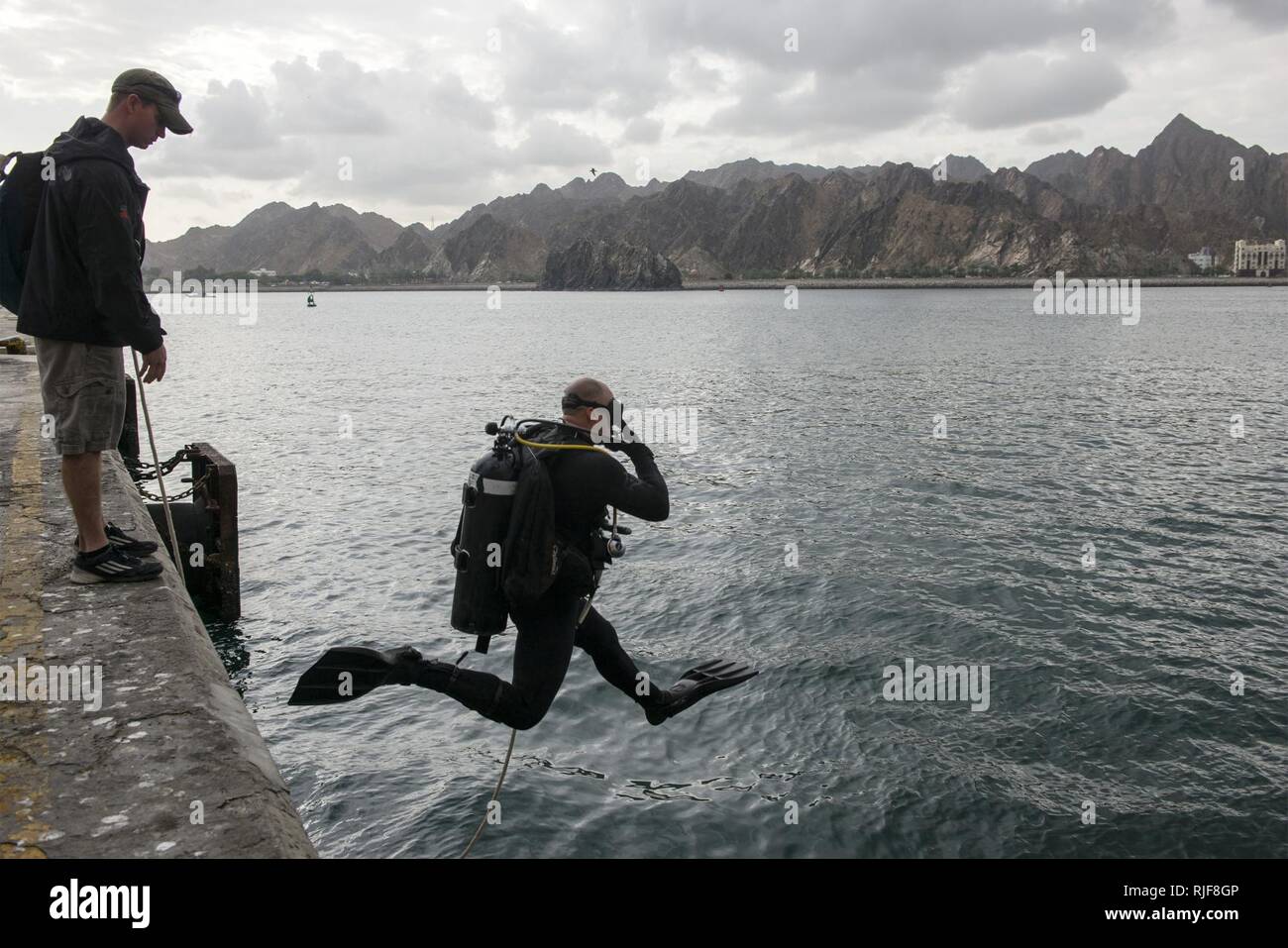 Chief Navy Diver Chris Dolan watches as Navy Diver 2nd Class Chris ...