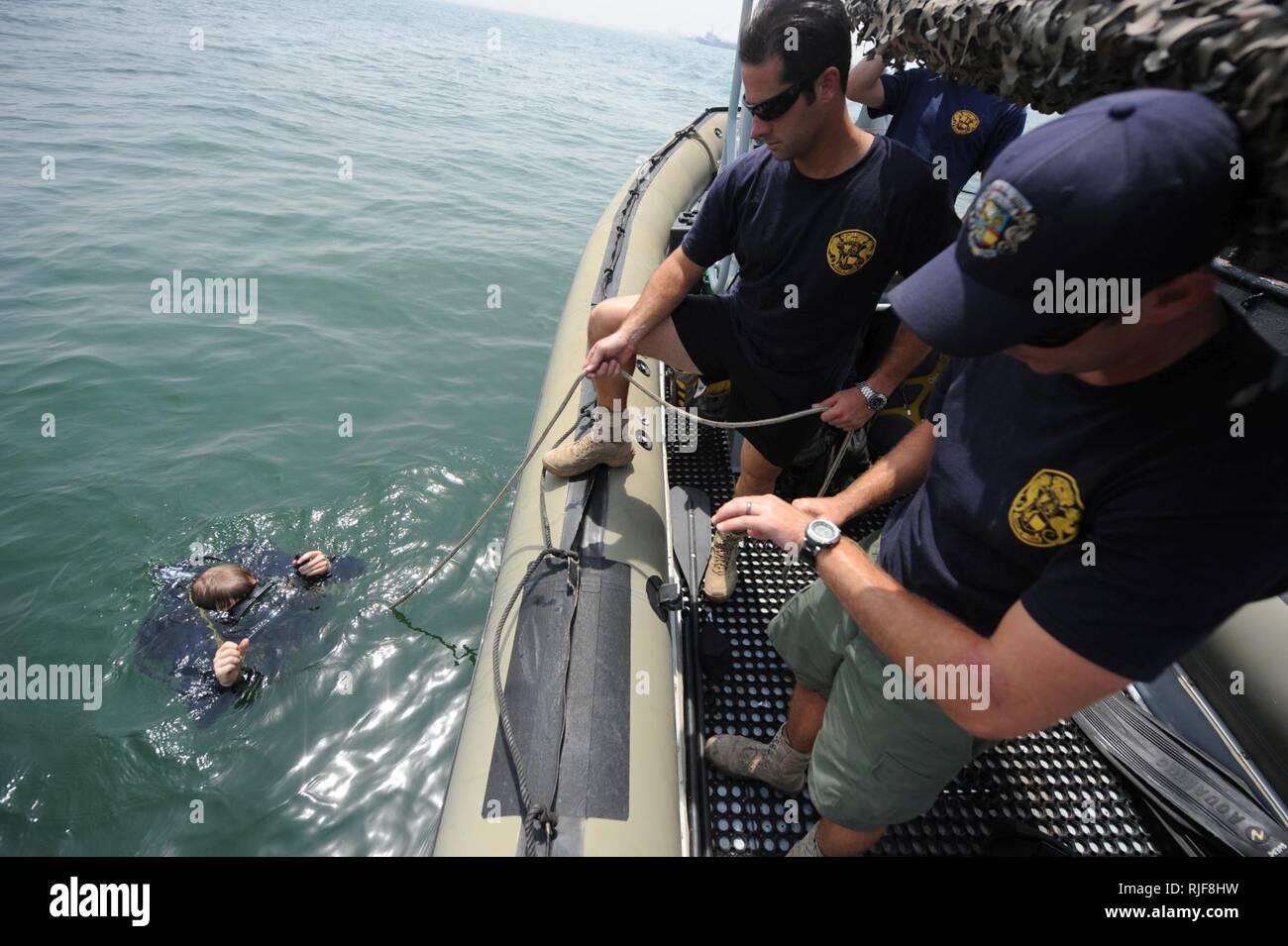 Navy Petty Officer 2nd Class Justin Cavitt, left, a diver; Navy Petty ...