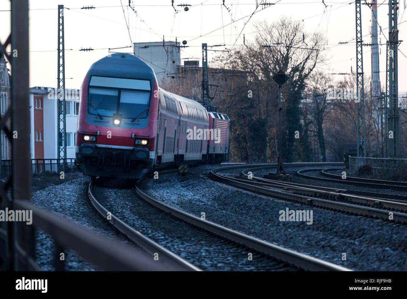 red train on train tracks Stock Photo - Alamy
