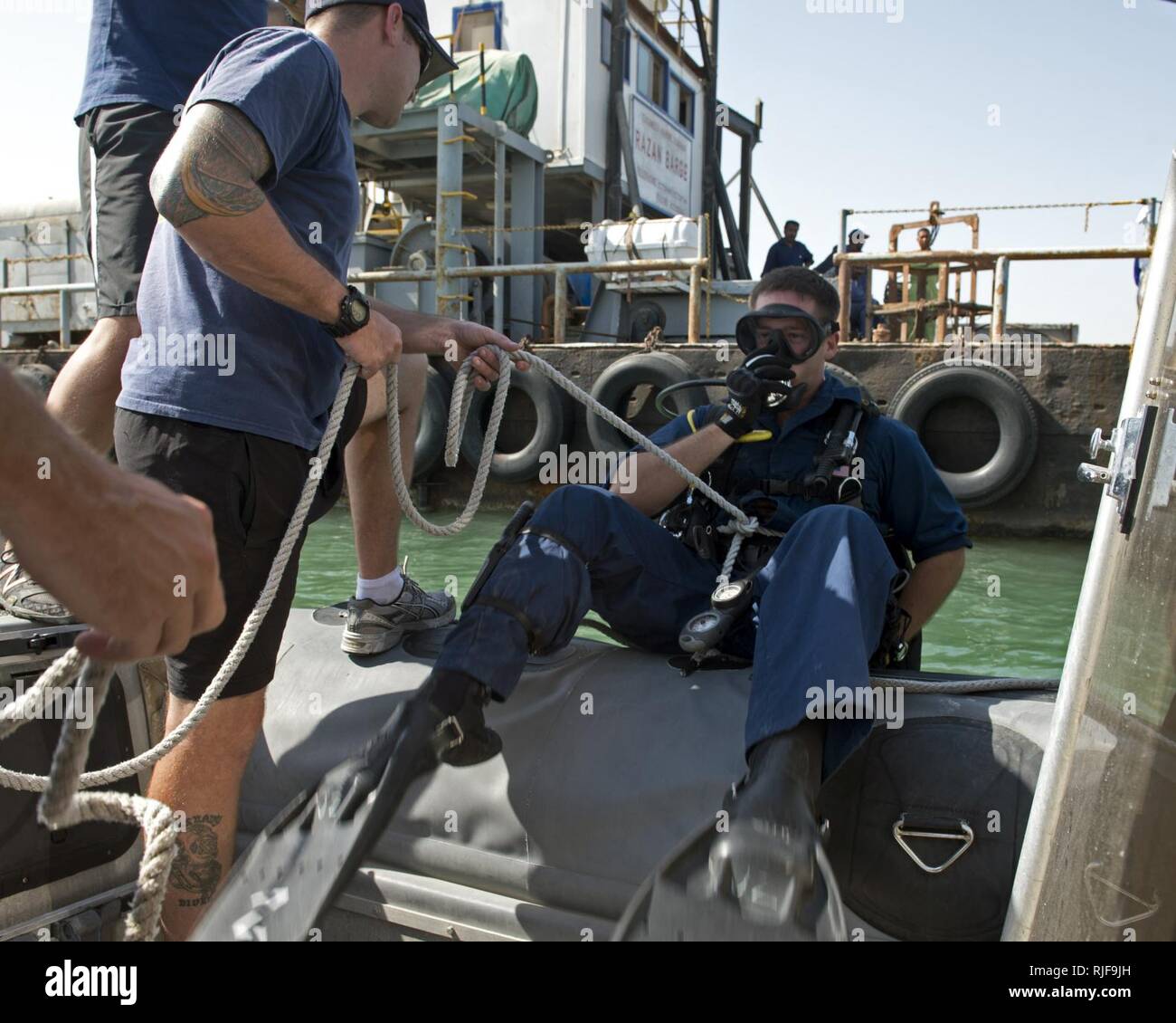 Navy Diver 3rd Class Joe Ziemba, right, tended by Navy Diver 2nd Class ...