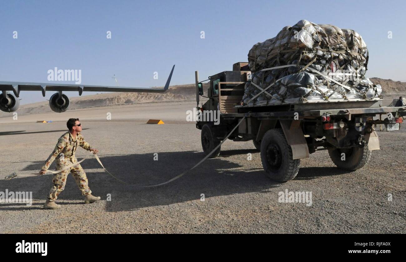 A Royal Australian Air Force airman throws a securing strap over the ...