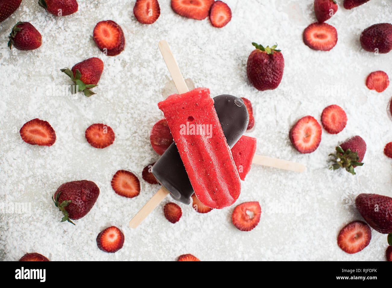 chocolate and strawberry stick ice cream surrounded by its ingredients ...