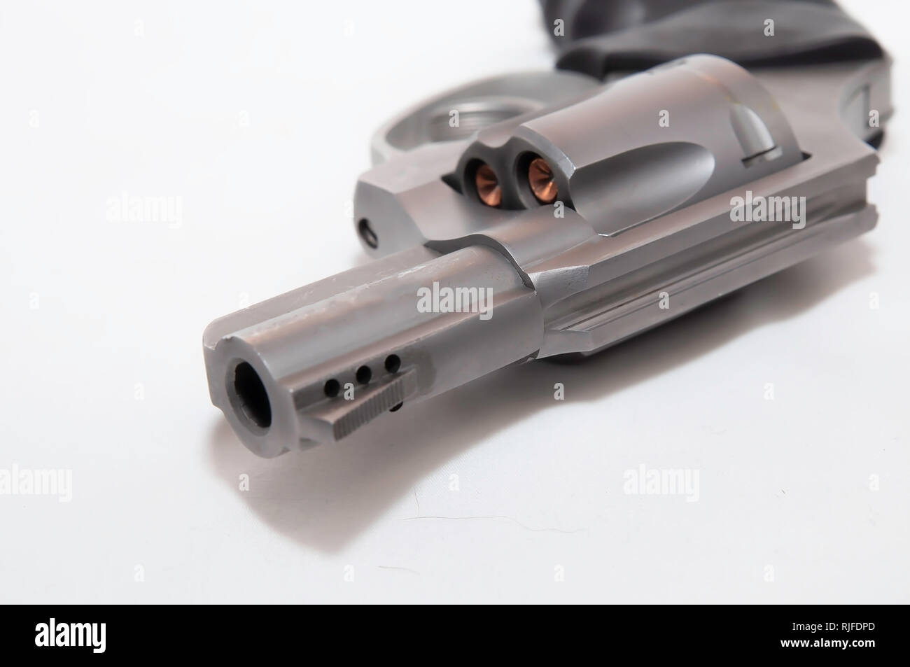 A close up of a stainless snub nose 357 magnum revolver on it's side ...