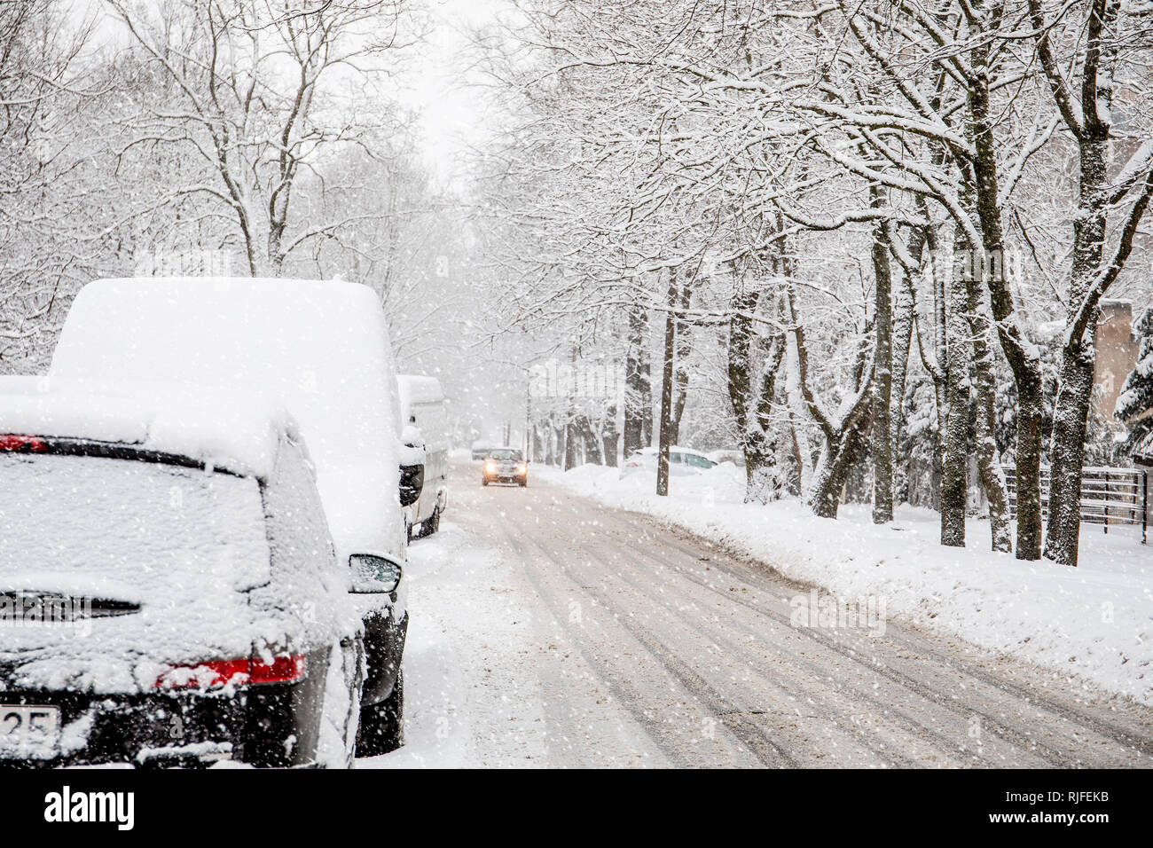 Snowstorm, ice and slippery city streets. Impassable roads and snow ...