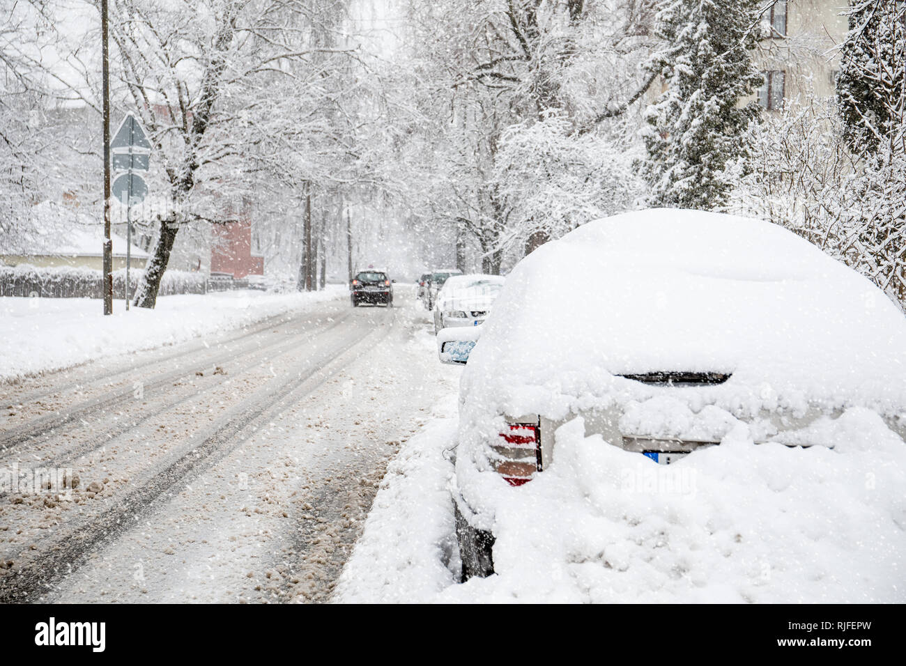 Snowstorm, ice and slippery city streets. Impassable roads and snow ...