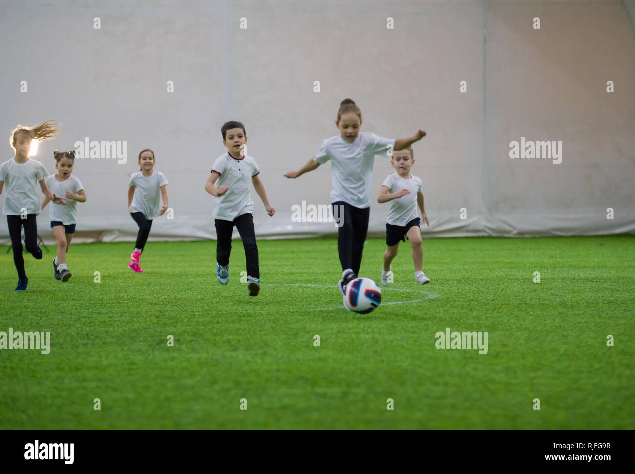 Little kids playing football indoors. Children football team playing on ...