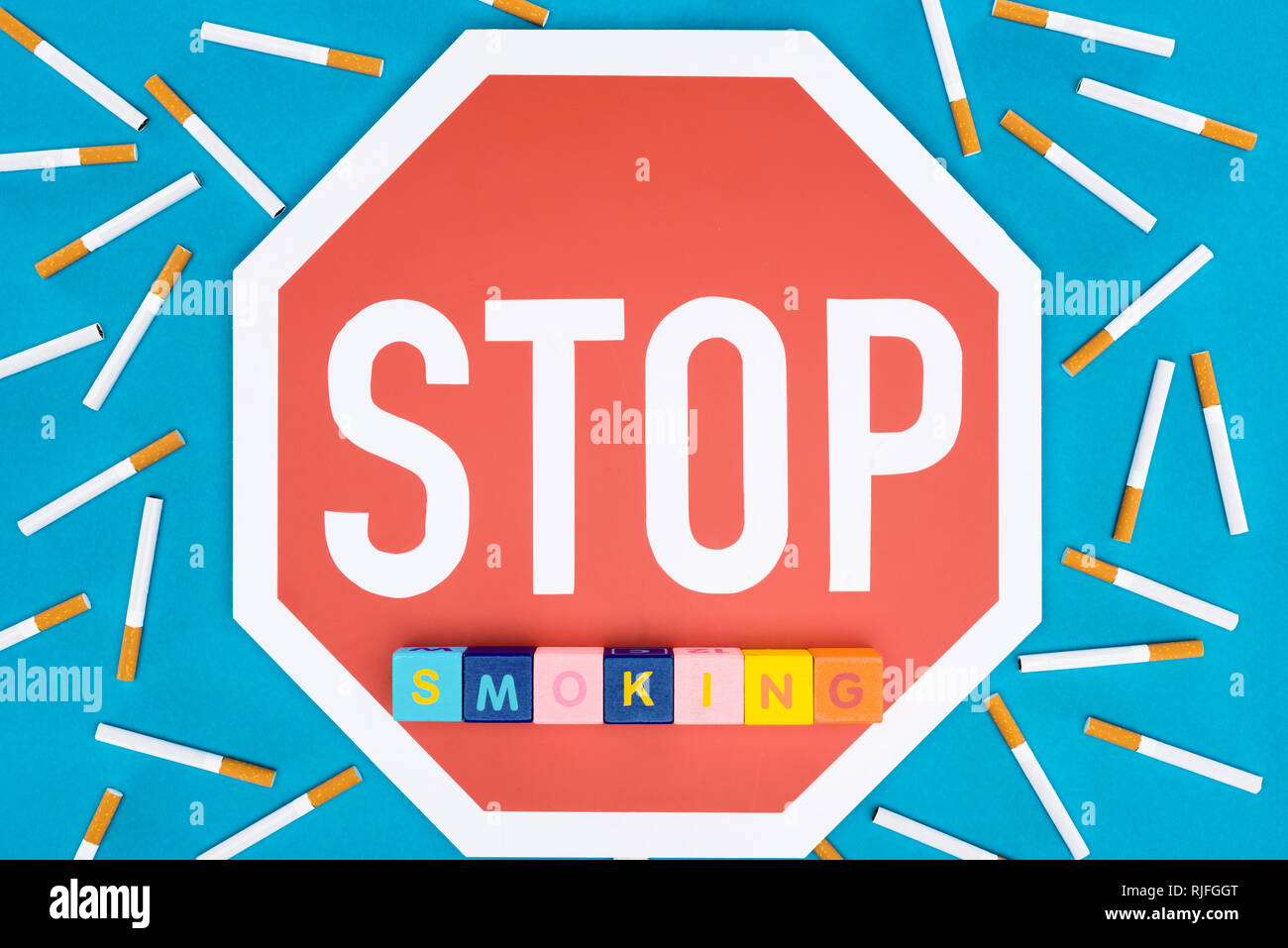 Top view of stop sign, cigarettes and blocks with letters isolated on ...