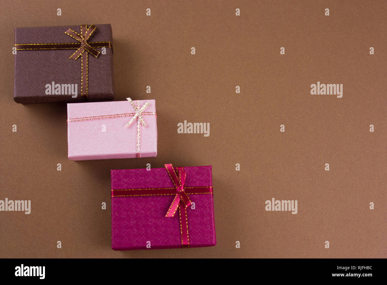 top view flat lay gift boxes on a brown background Stock Photo - Alamy