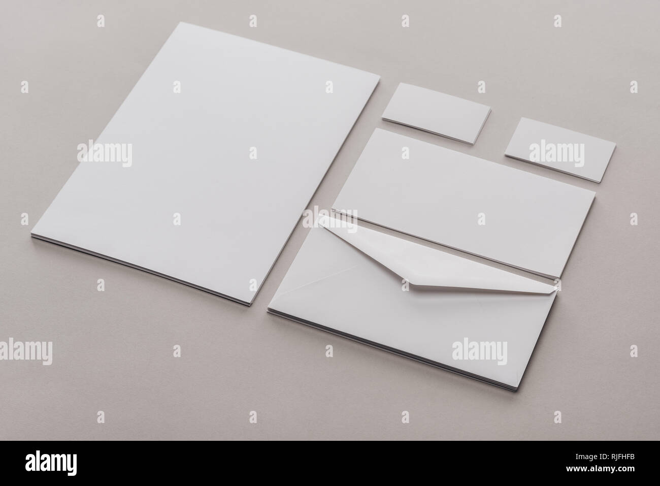flat lay with white empty papers and envelopes on grey background Stock ...