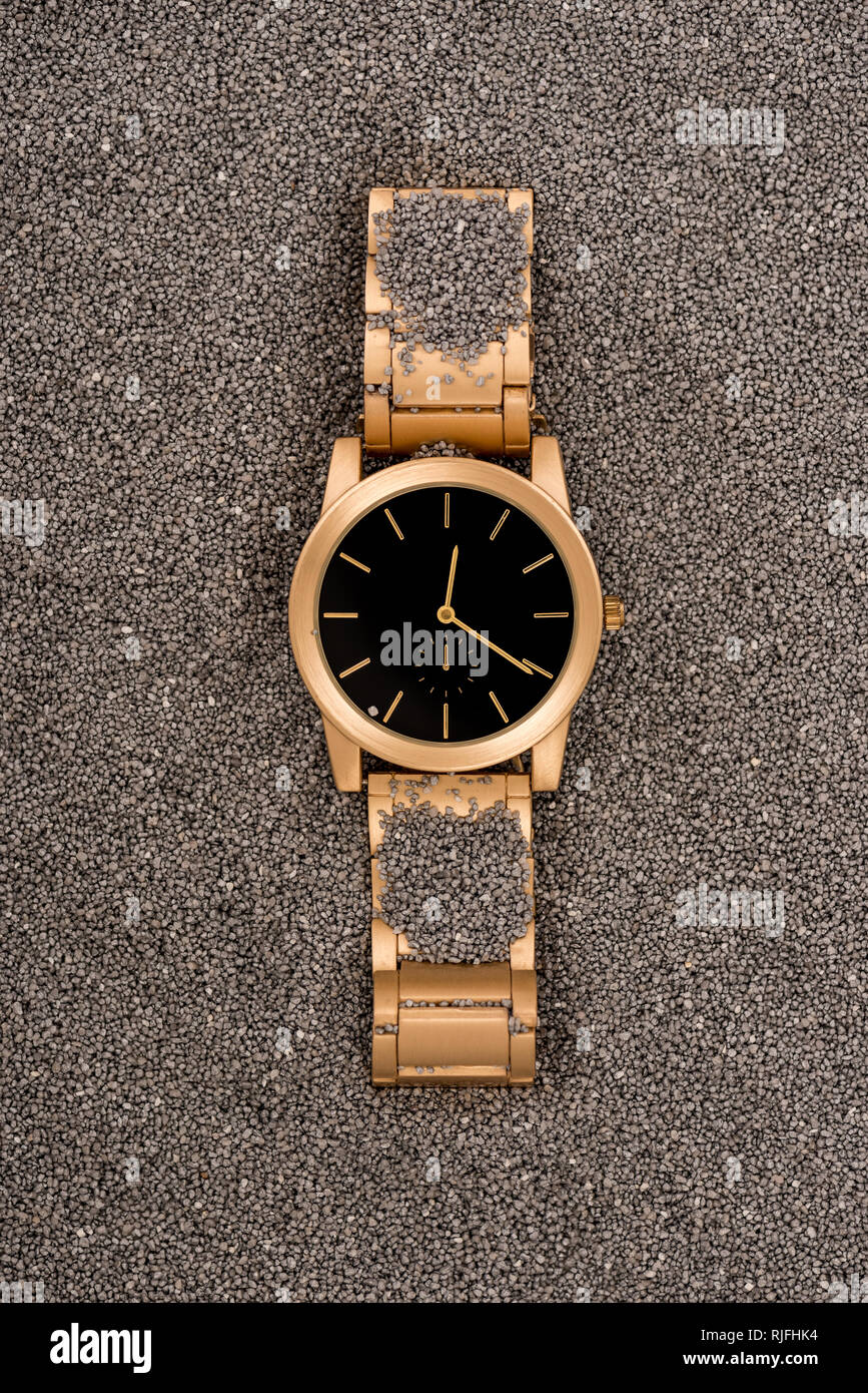 top view of luxury wristwatch lying on golden sand Stock Photo - Alamy