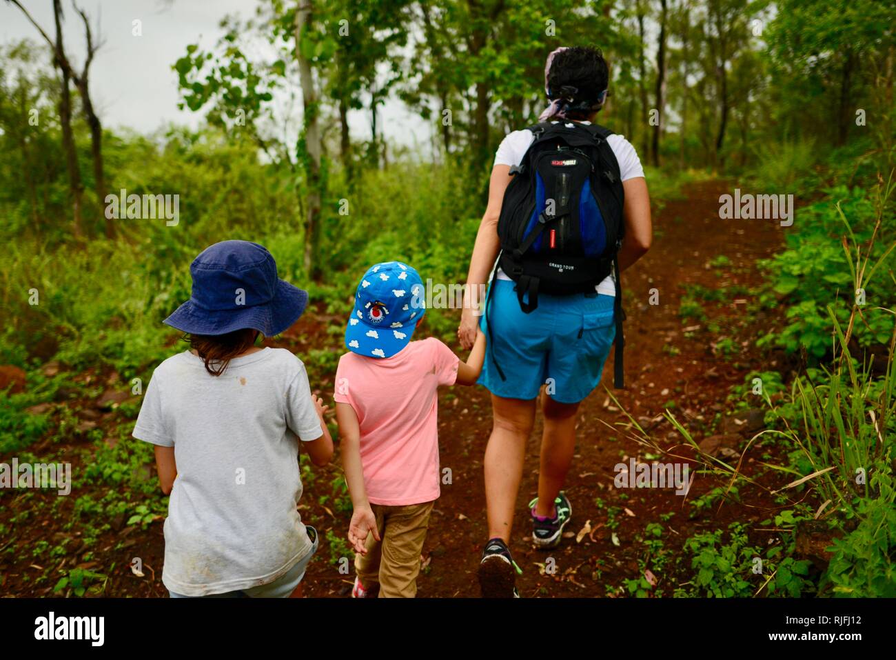 Young school age children walking along a dirt track, Moongun walking ...