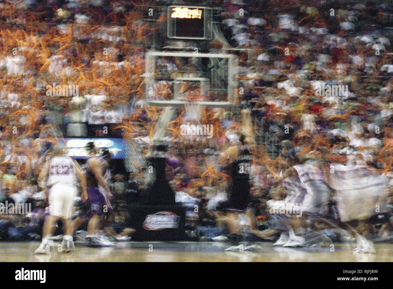 An NBA basketball player shoots a free throw while the crowd tries to ...