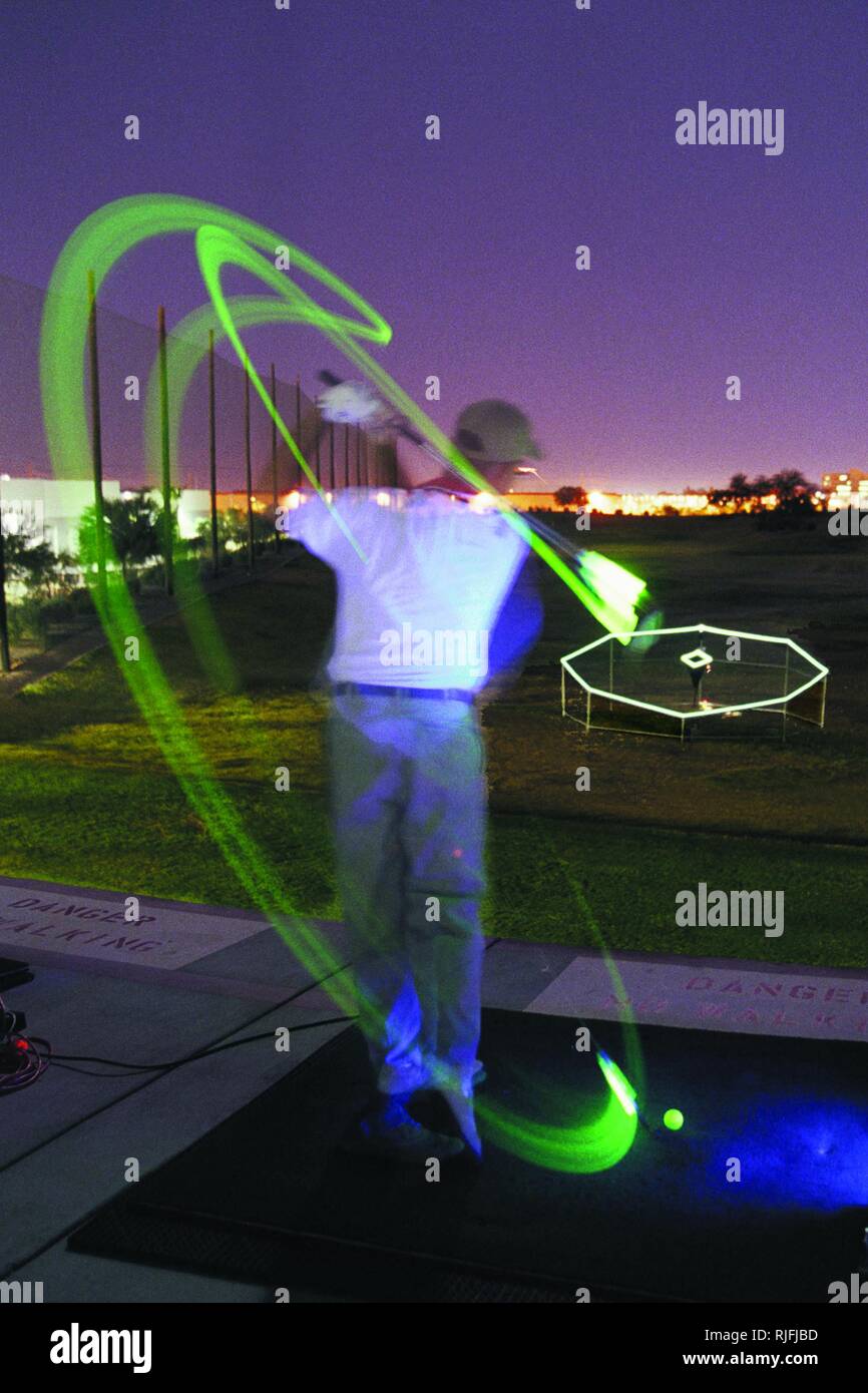 A glow stick is attached to a golfers club to capture the complete ...