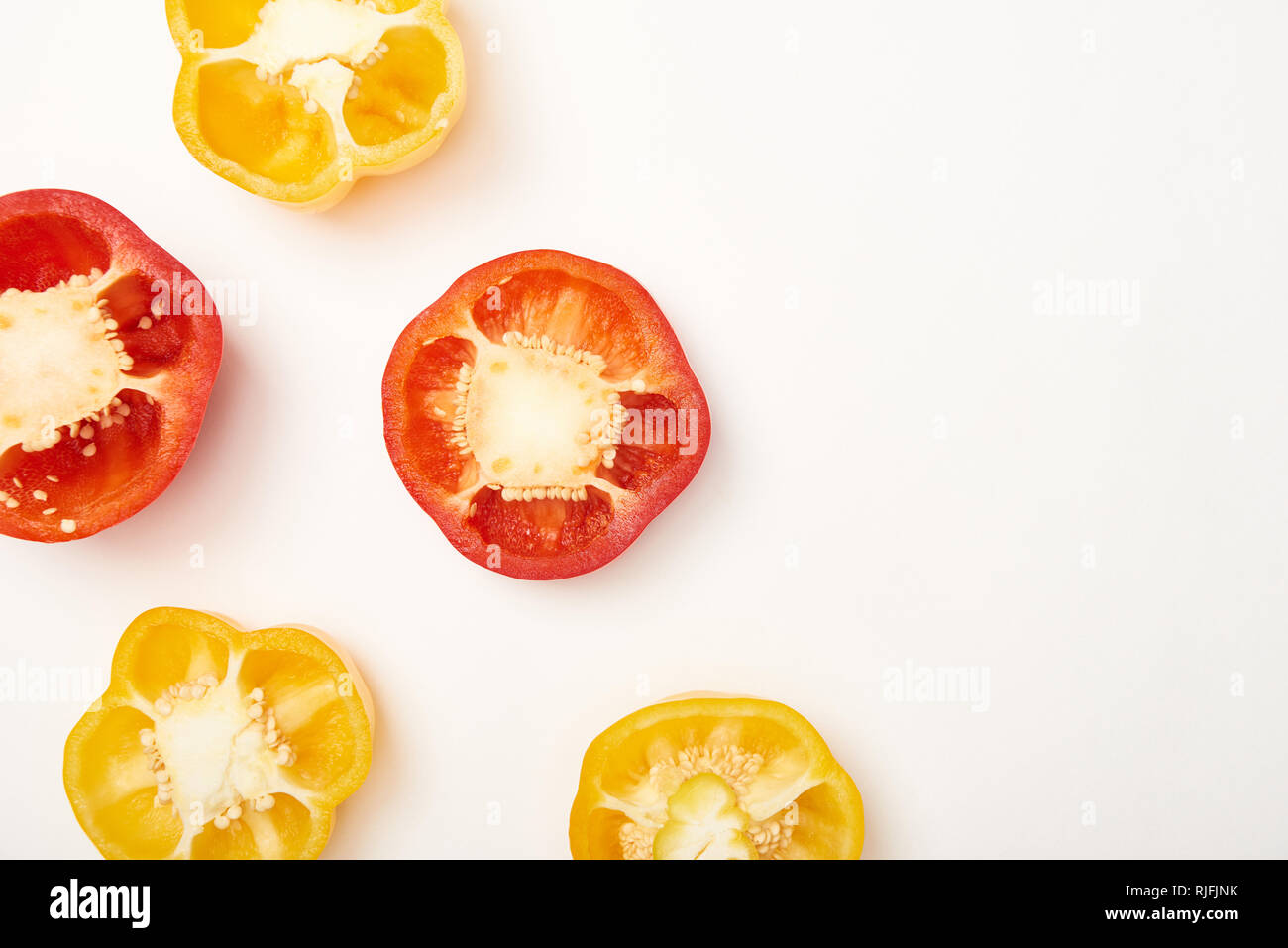 Flat lay with cut bell peppers on white background Stock Photo - Alamy