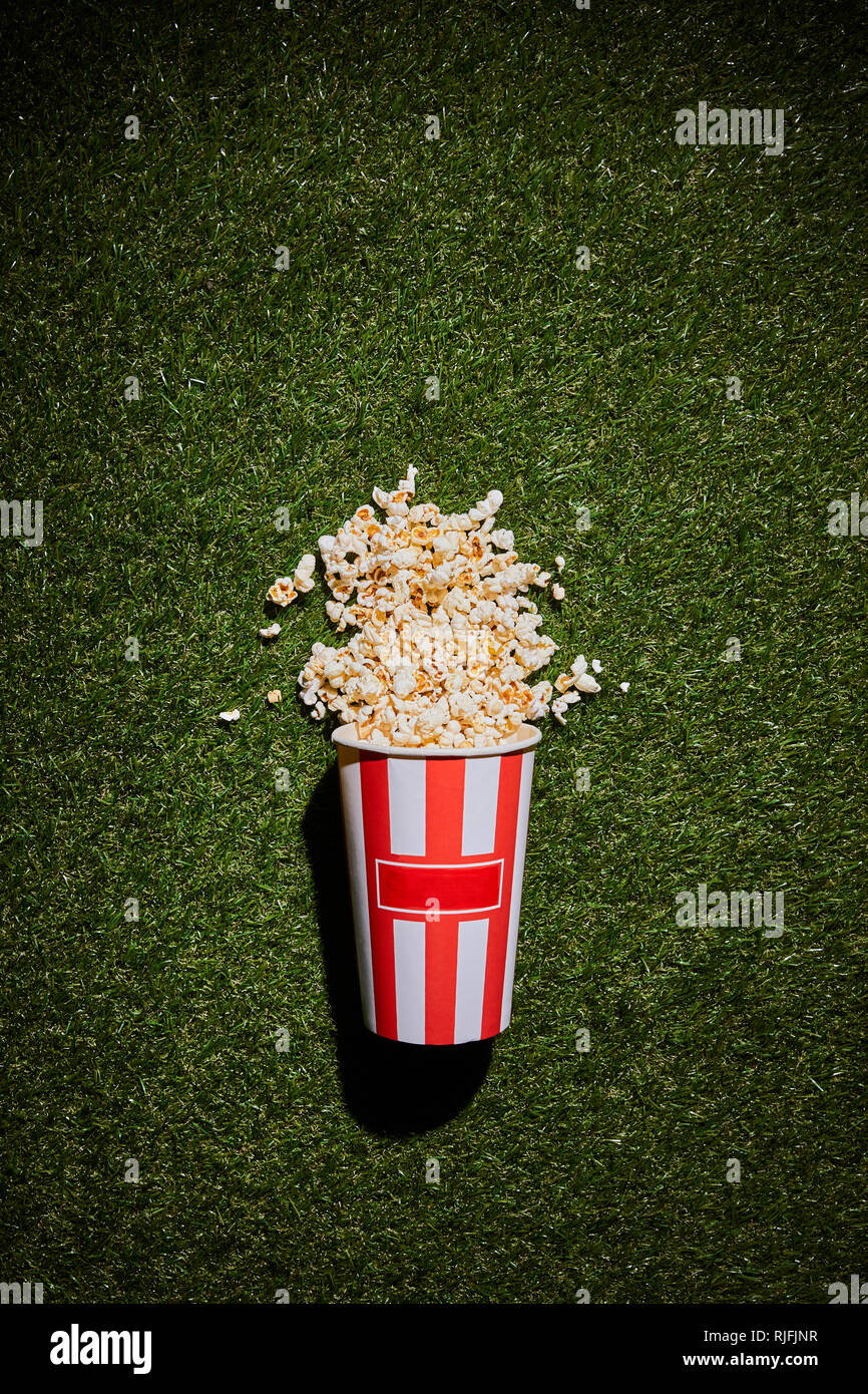 top view of popcorn lying on grass near popcorn cup Stock Photo - Alamy