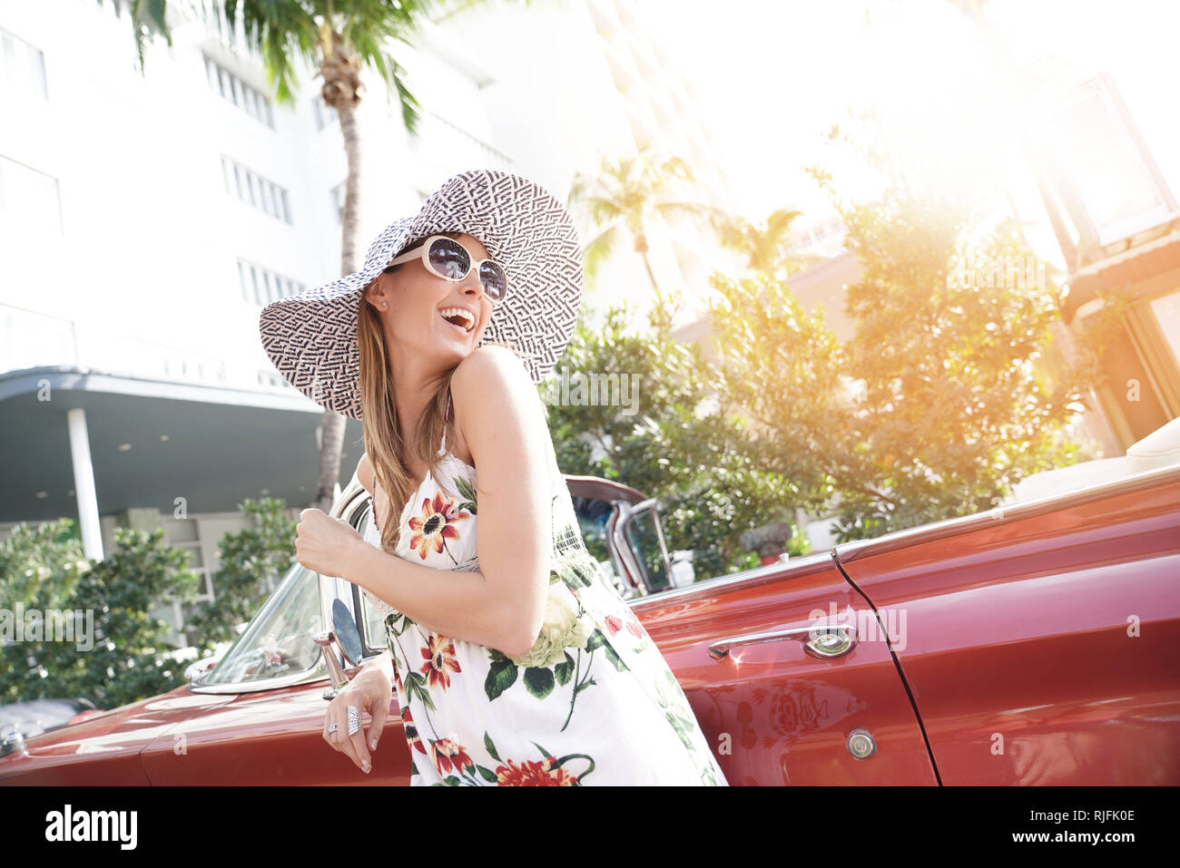 Model posing by old-fashioned car Stock Photo - Alamy