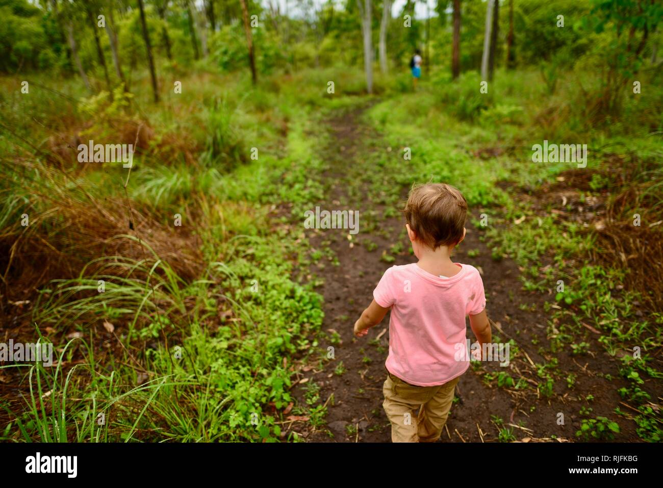 Young school age children walking along a dirt track, Moongun walking ...