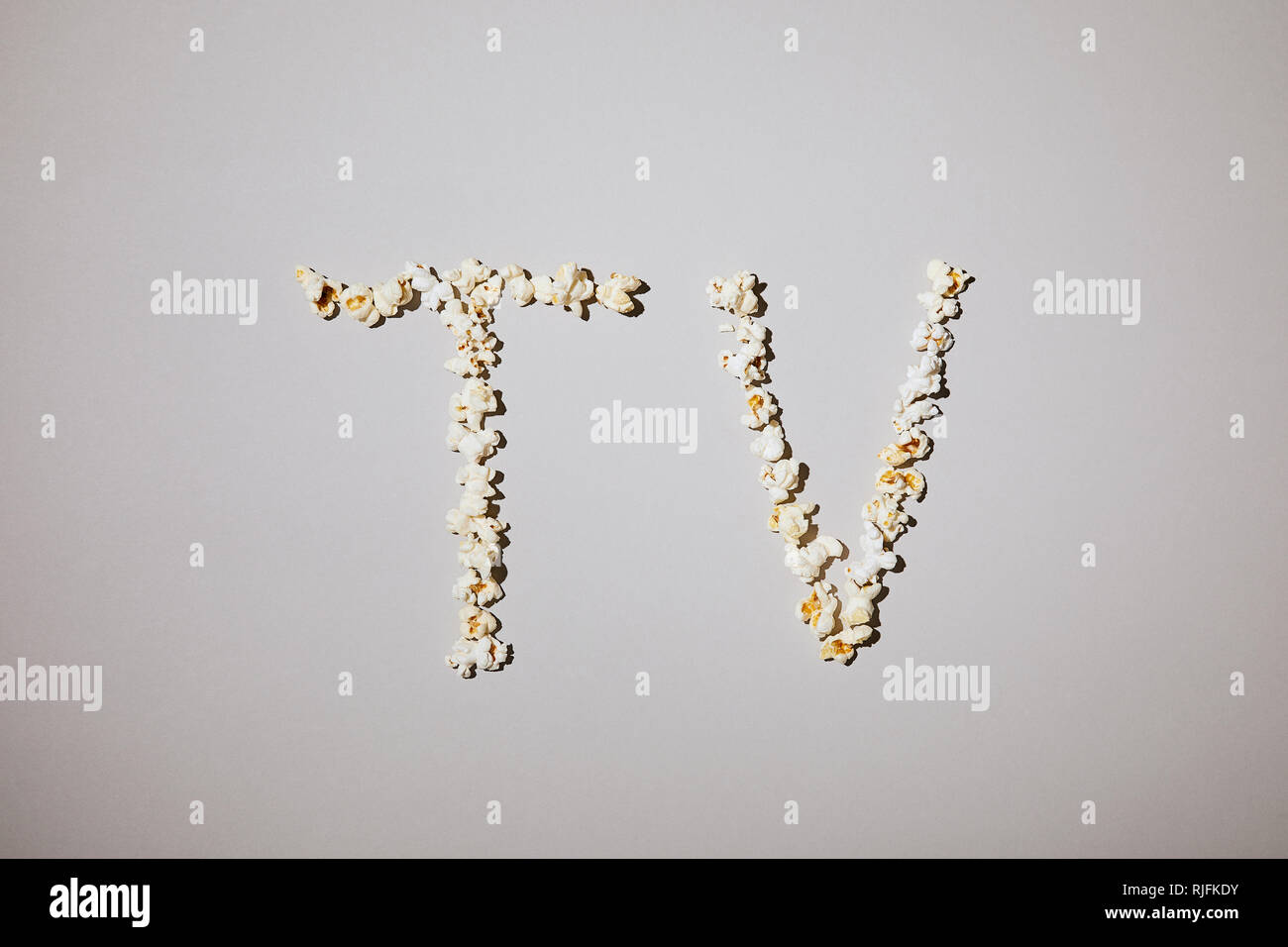 flat lay of tasty popcorn with tv lettering isolated on white Stock ...