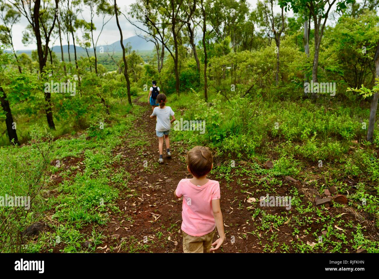 Young school age children walking along a dirt track, Moongun walking ...