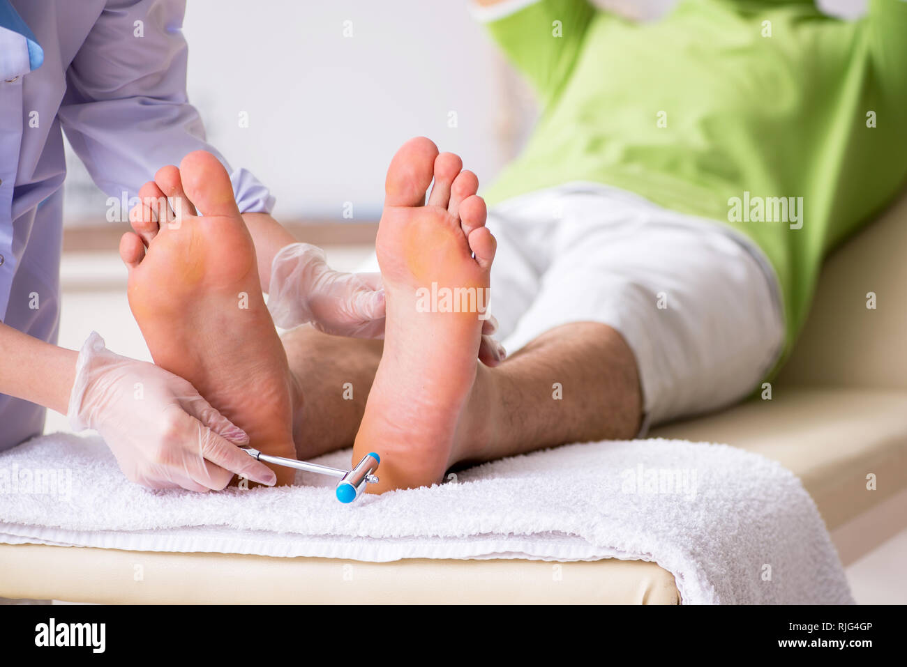 Podiatrist treating feet during procedure Stock Photo - Alamy